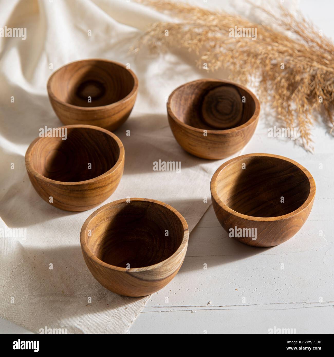 handmade rustic wooden bowls on the white table with natural style ...
