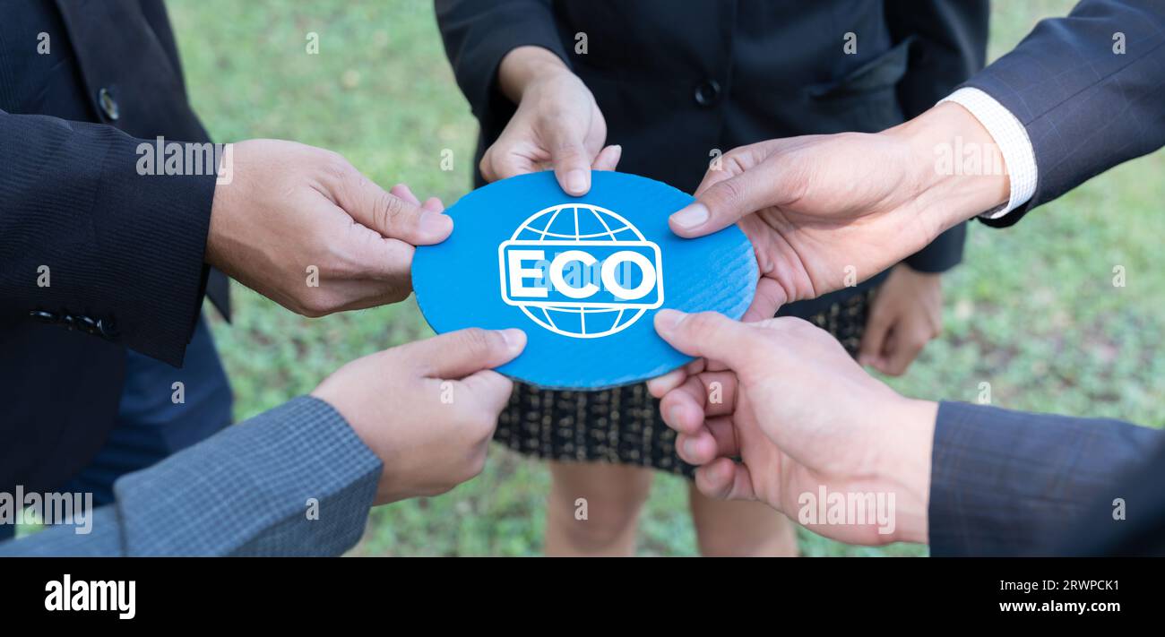 Business people holding ECO friendly idea symbol together as group of ...