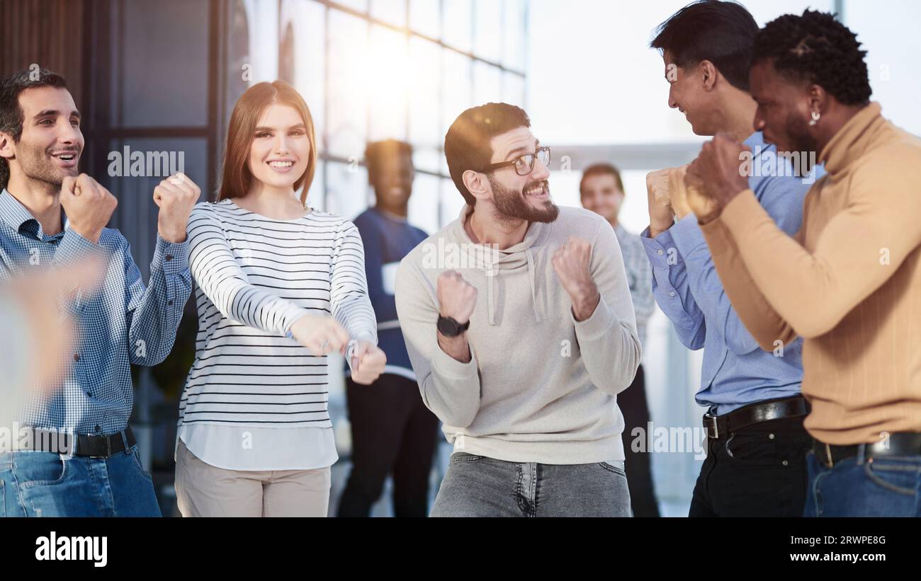 Business people celebrates and clench their fists in the air as a ...