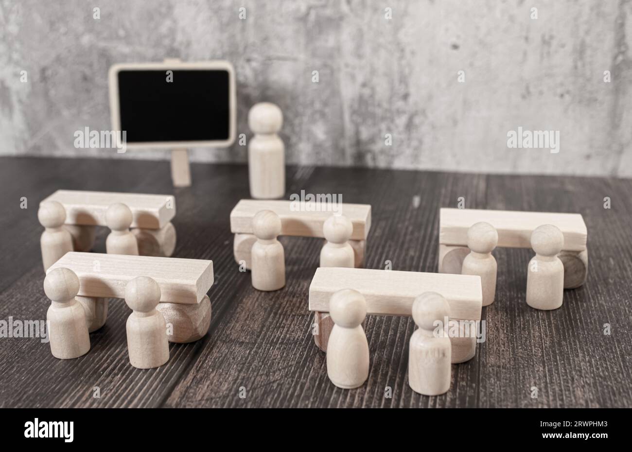 Wooden figures peg dolls stand above wooden cube among others with vote ...