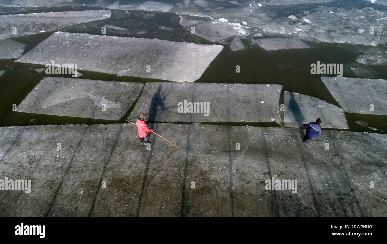 Farmers use long poles to push ice across the water, North China Stock ...