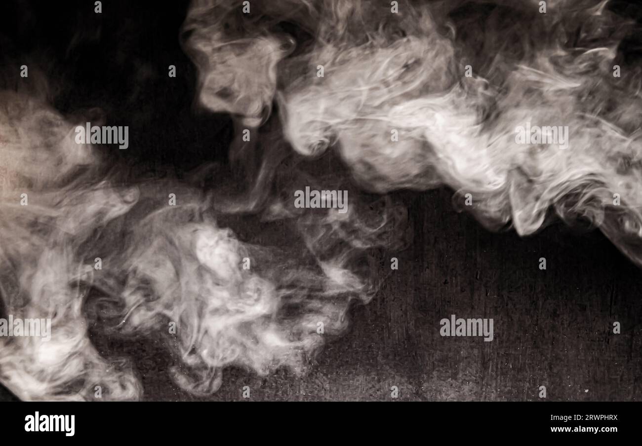 Billowing cloud of white smoke against dark background Stock Photo - Alamy
