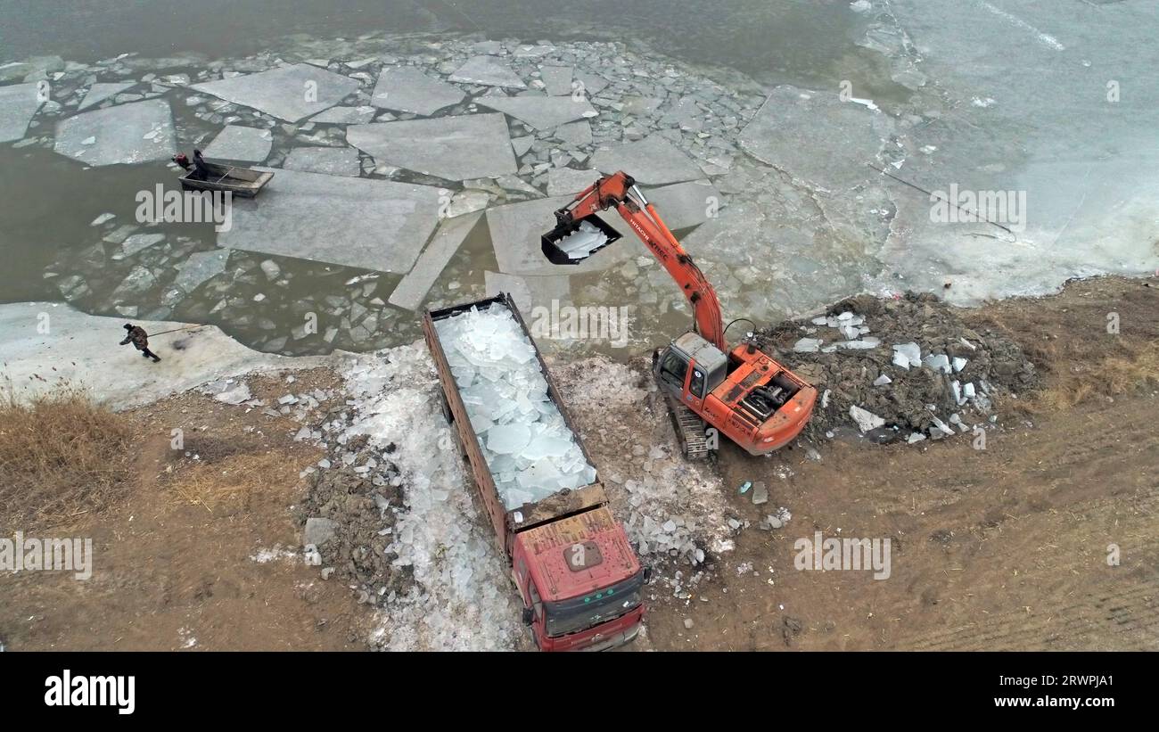 Workers use heavy trucks to transport ice, North China Stock Photo - Alamy