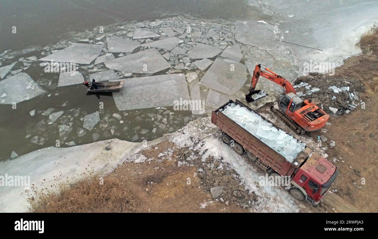 Workers use heavy trucks to transport ice, North China Stock Photo - Alamy