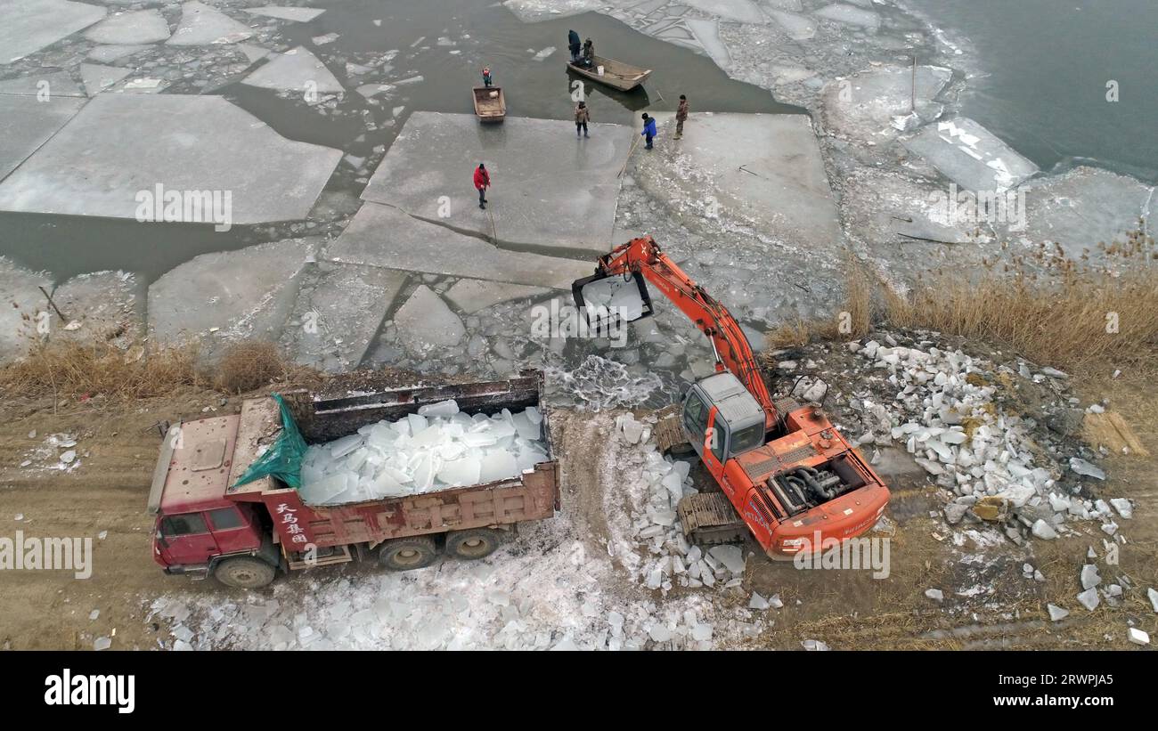 Workers use heavy trucks to transport ice, North China Stock Photo - Alamy