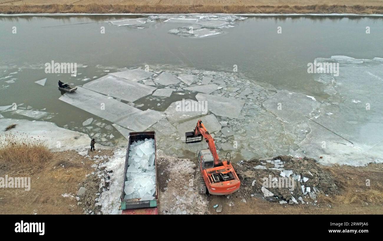 Workers use heavy trucks to transport ice, North China Stock Photo - Alamy