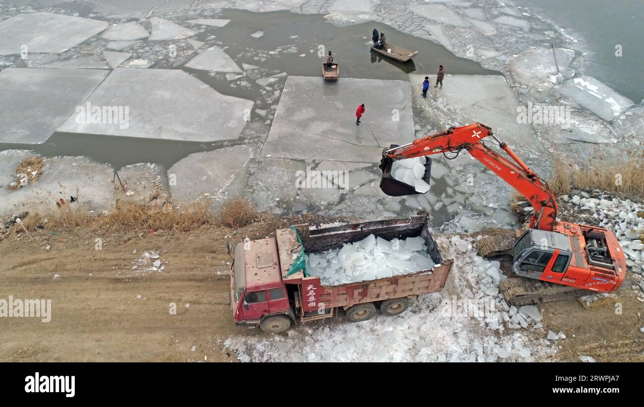 Workers use heavy trucks to transport ice, North China Stock Photo - Alamy