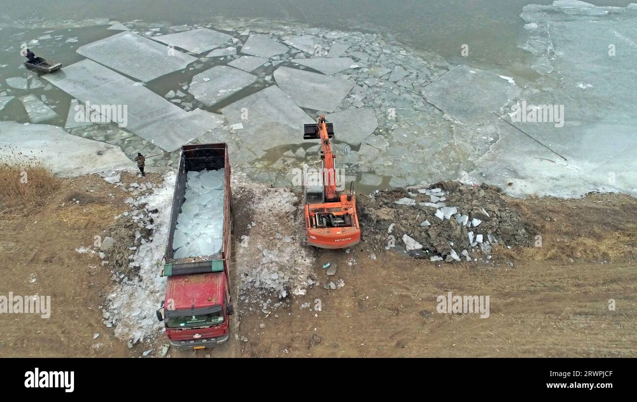 Workers use heavy trucks to transport ice, North China Stock Photo - Alamy
