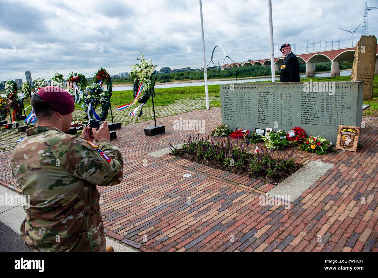 An American soldier is seen taking a photo of the monument. At the Waal Crossing Memorial ...