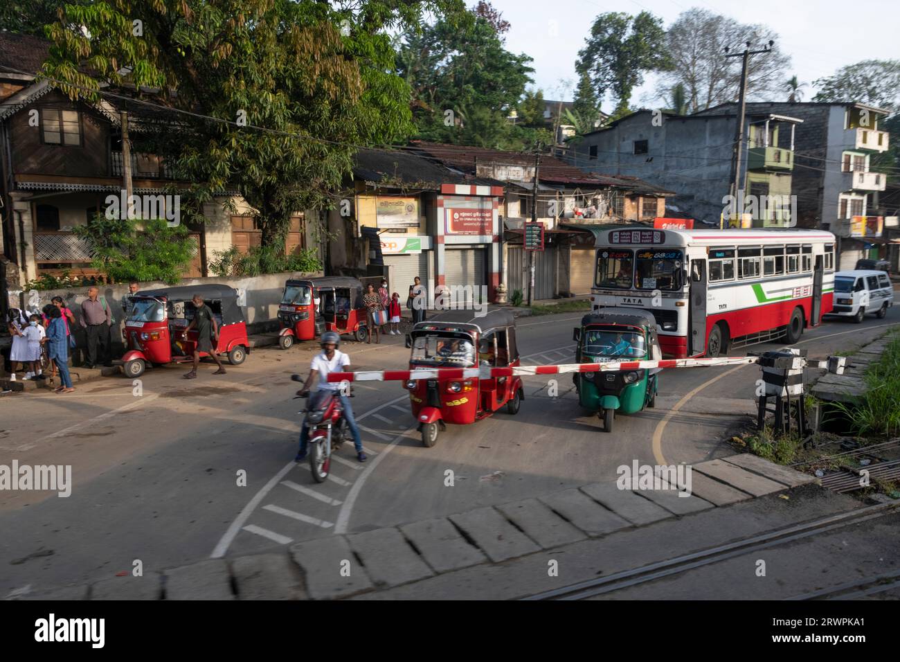 Sri Lanka. Level crossing (train crossing); rickshaw (tuk-tuk) taxis ...