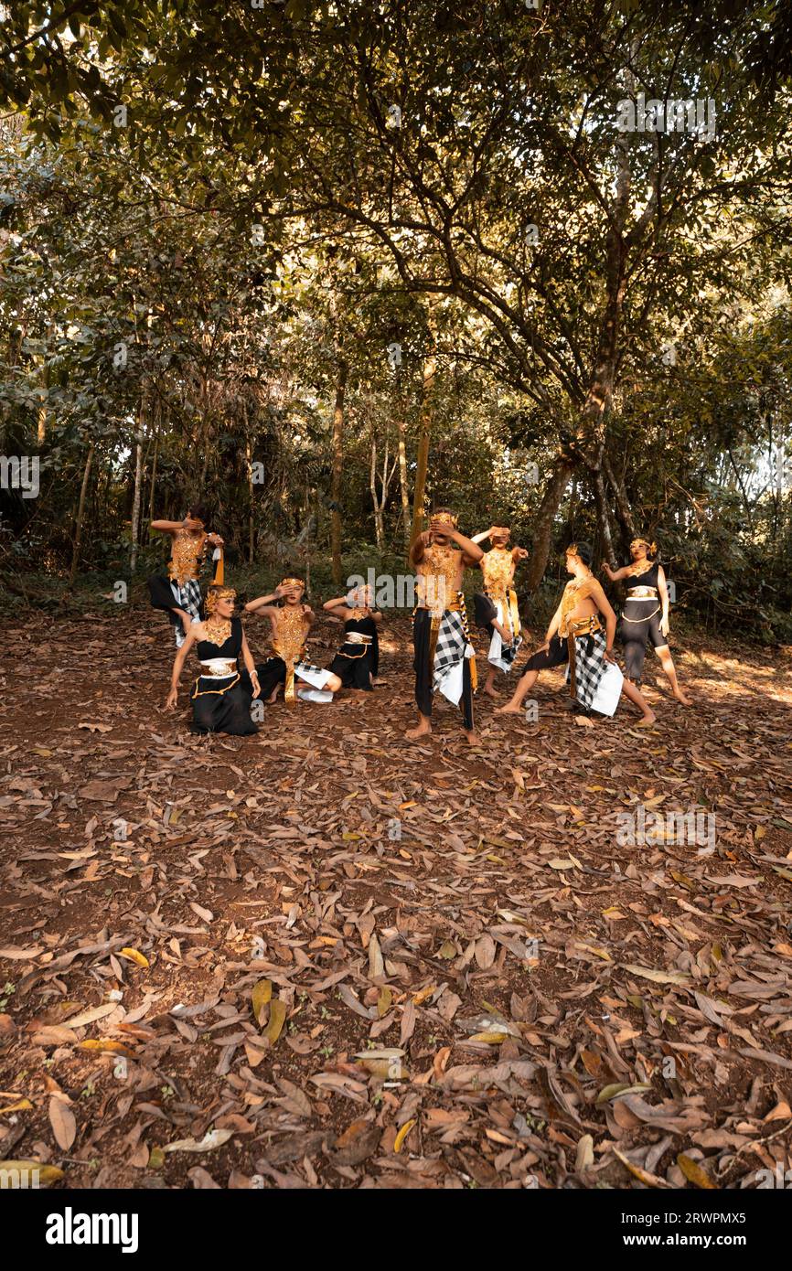 Javanese dance in golden costumes while wearing a makeup pose together ...