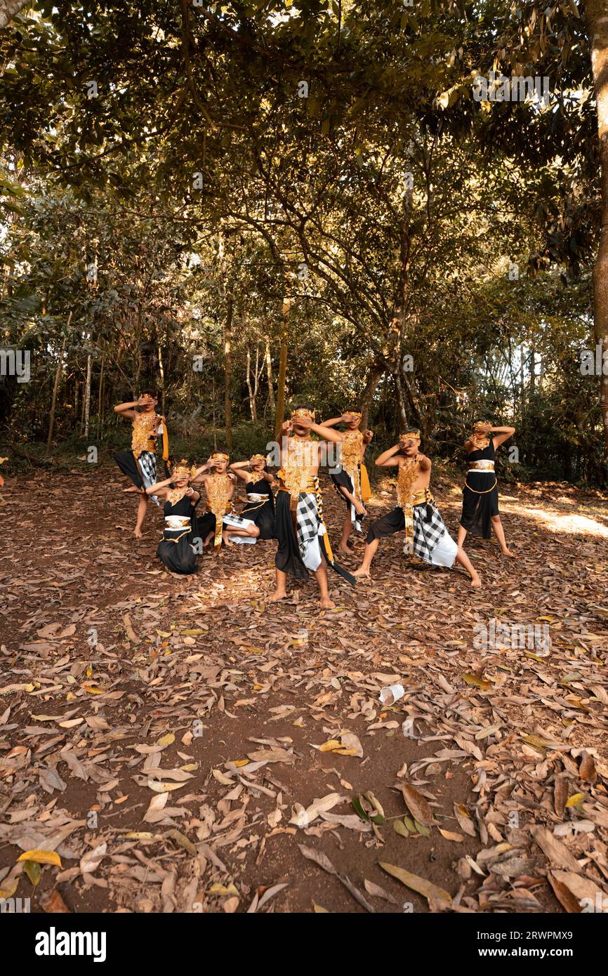 Javanese dance in golden costumes while wearing a makeup pose together ...