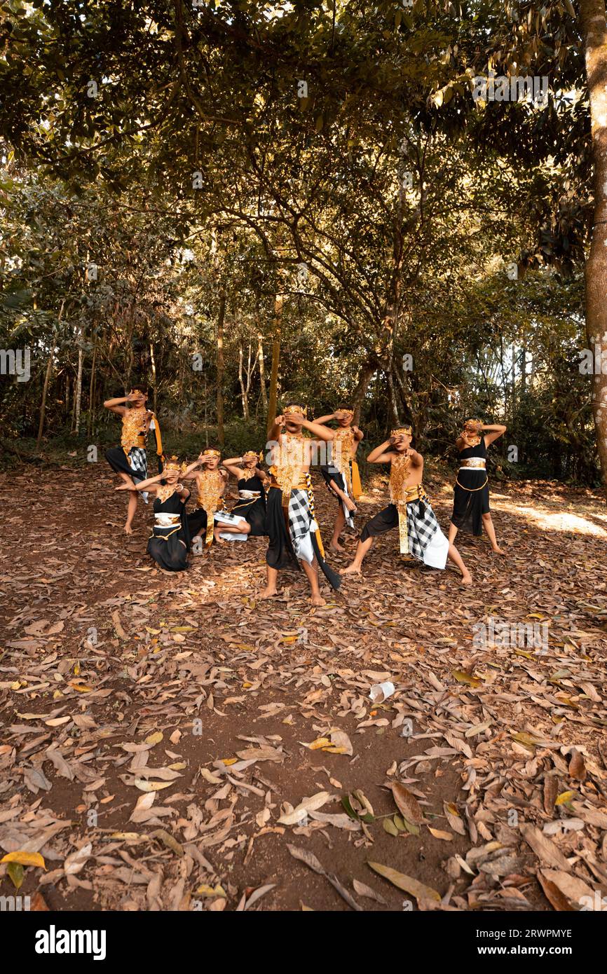 Javanese dance in golden costumes while wearing a makeup pose together ...