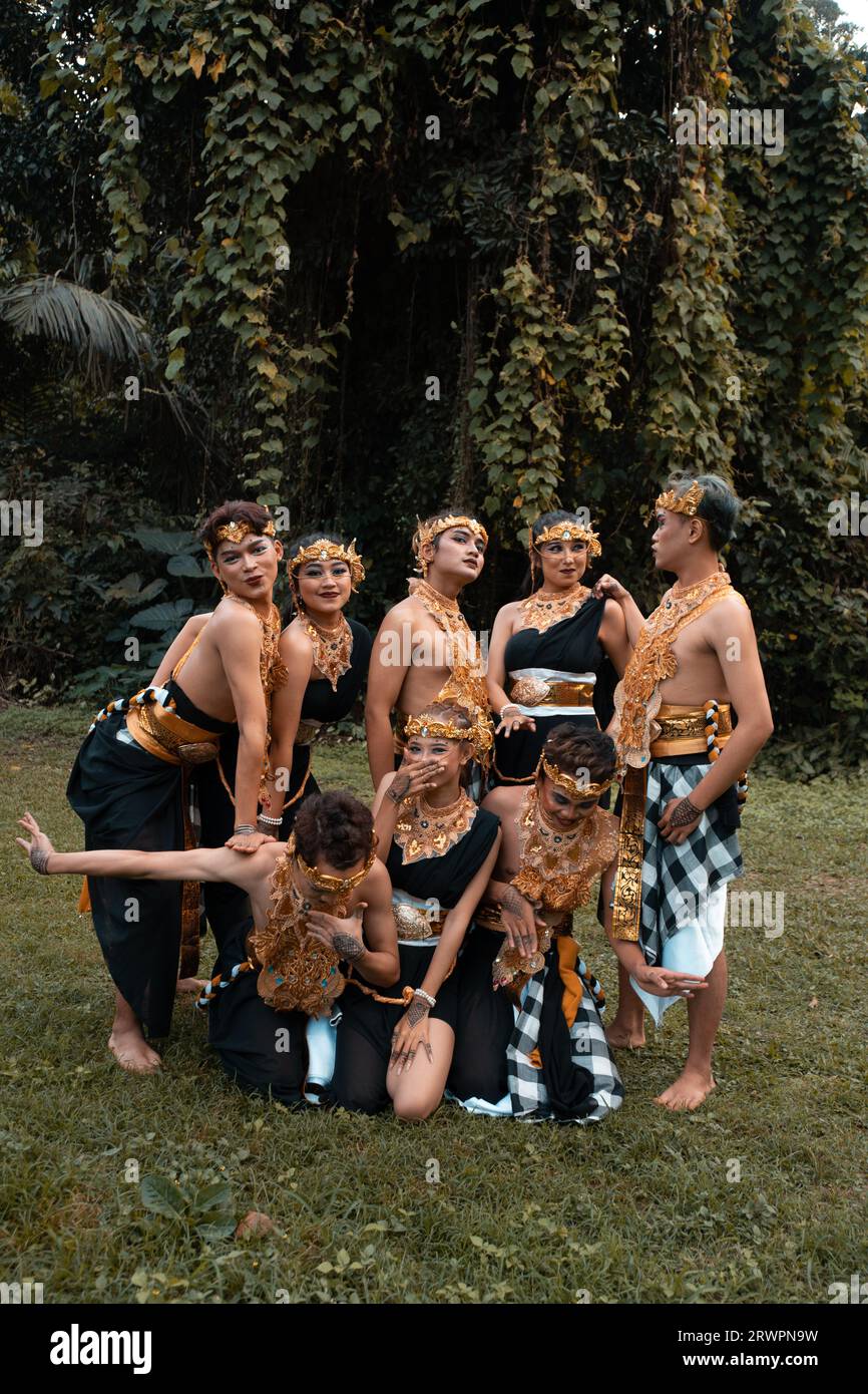 A bunch of Asian people having fun while taking a photo shoot with a ...