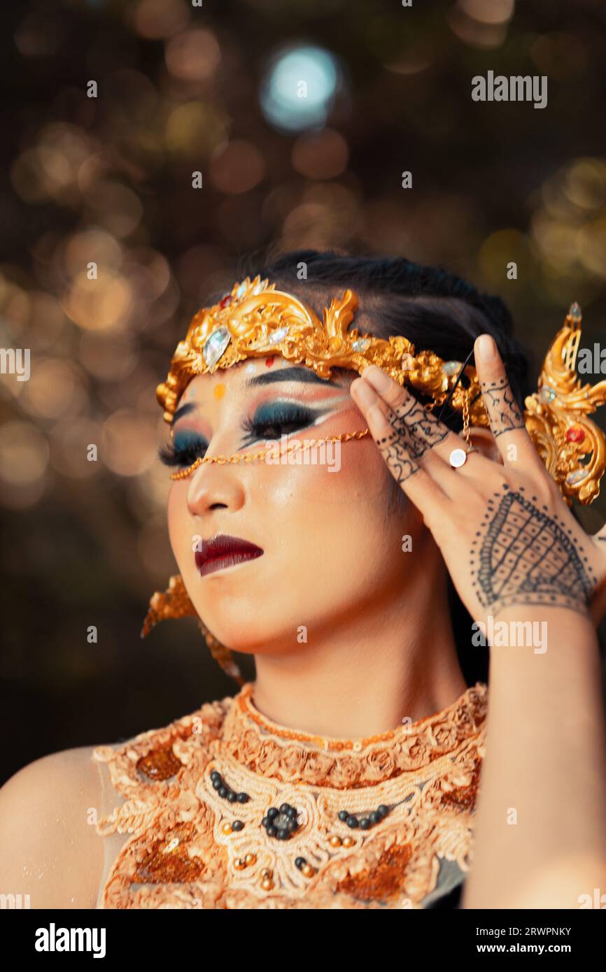 Asian woman with makeup covering his face with her hand while in makeup ...