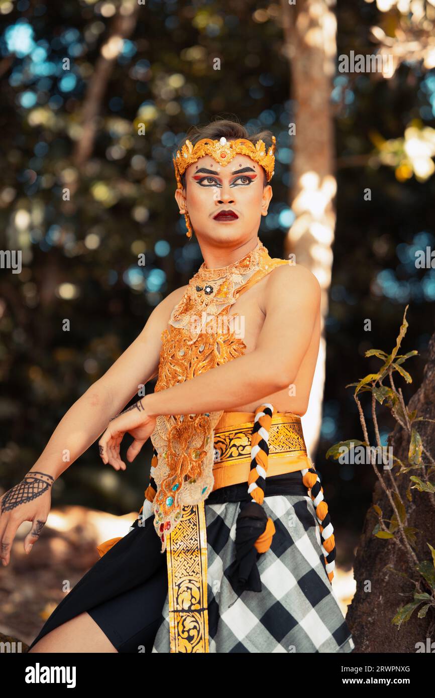Balinese dancer performs the dance in golden costume and golden crown ...