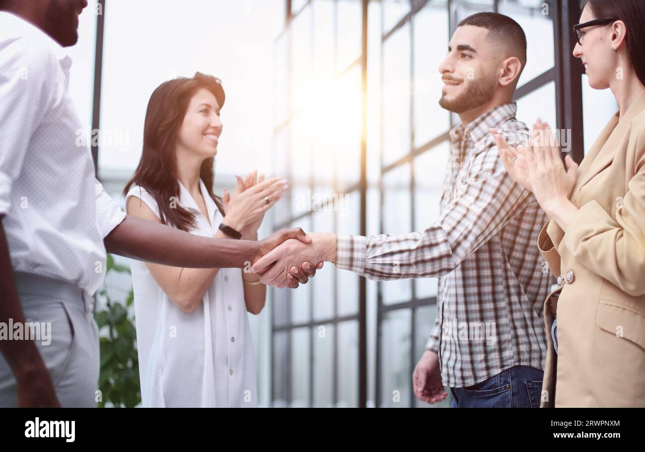 A group of business people hang out together during a coffee break in ...