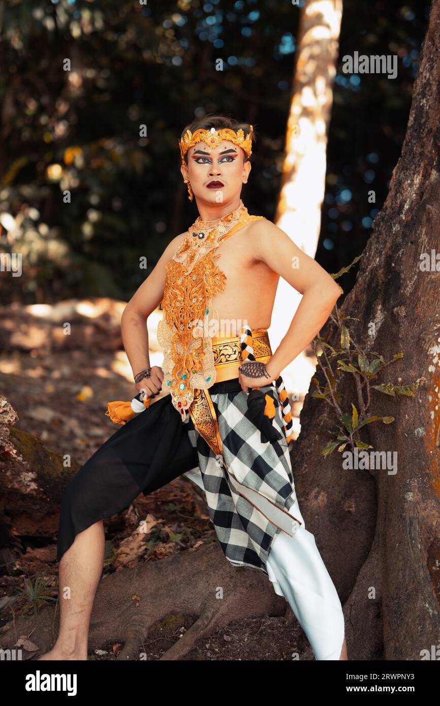 Balinese dancer performs the dance in golden costume and golden crown ...