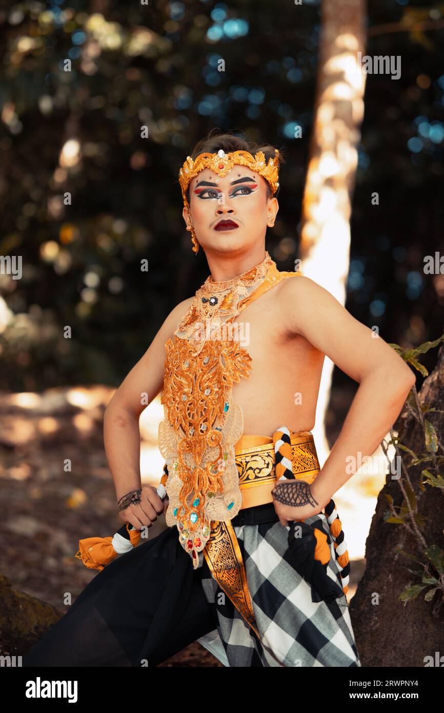 Balinese dancer performs the dance in golden costume and golden crown ...