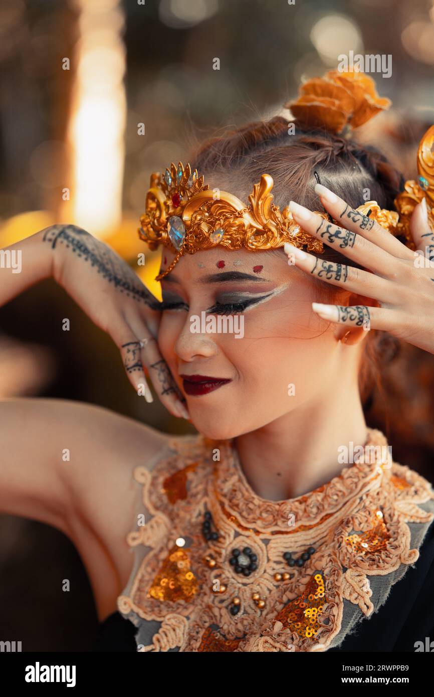Portrait of a queen in her golden crown and a golden necklace with ...