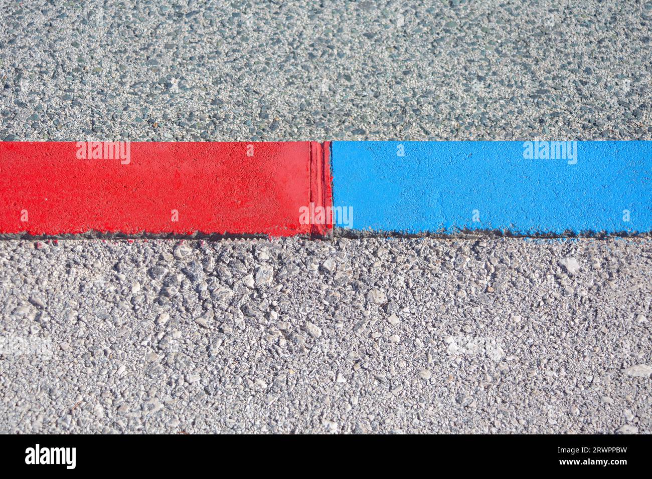 Red and blue line on the asphalt road. Abstract background and texture ...