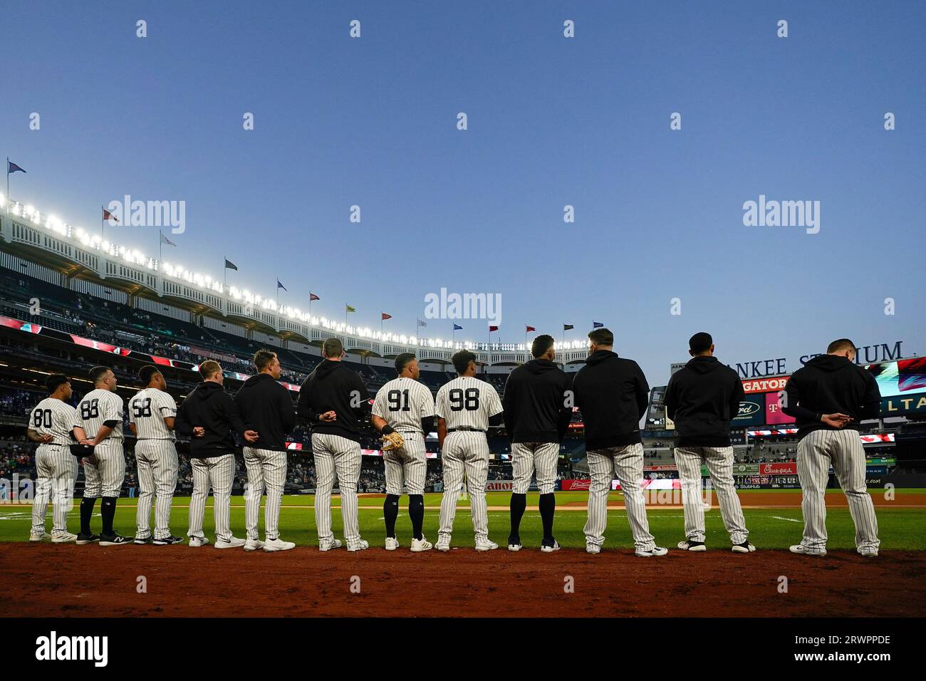 New York Yankees' players stand on the field before a baseball game ...