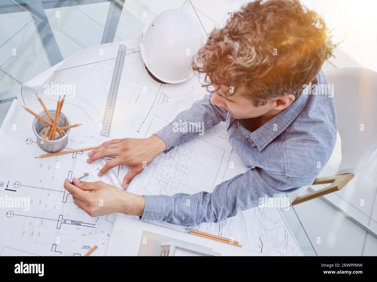 Young handsome architect engineer working on design plan Stock Photo ...