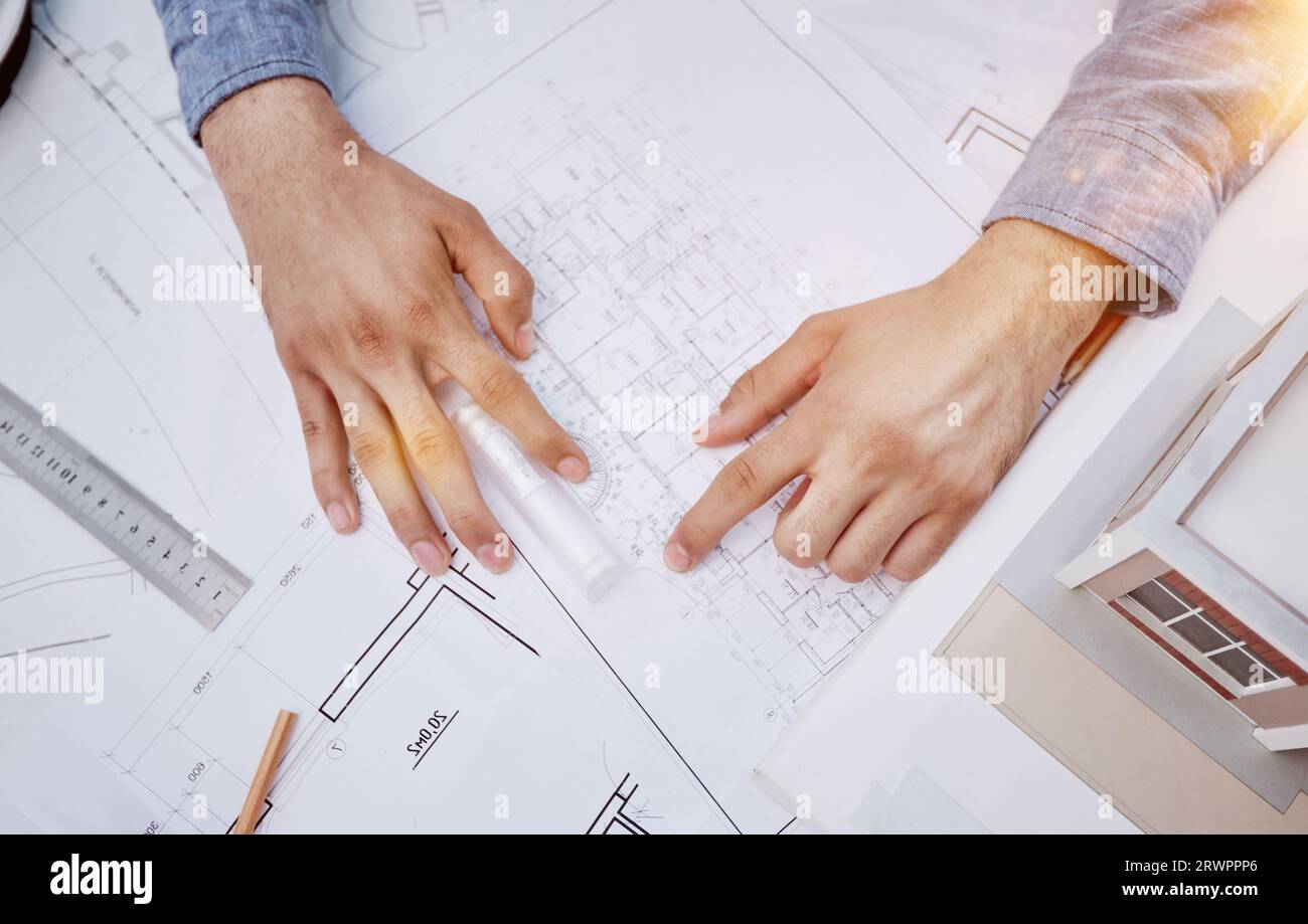 Young handsome architect engineer working on design plan Stock Photo ...