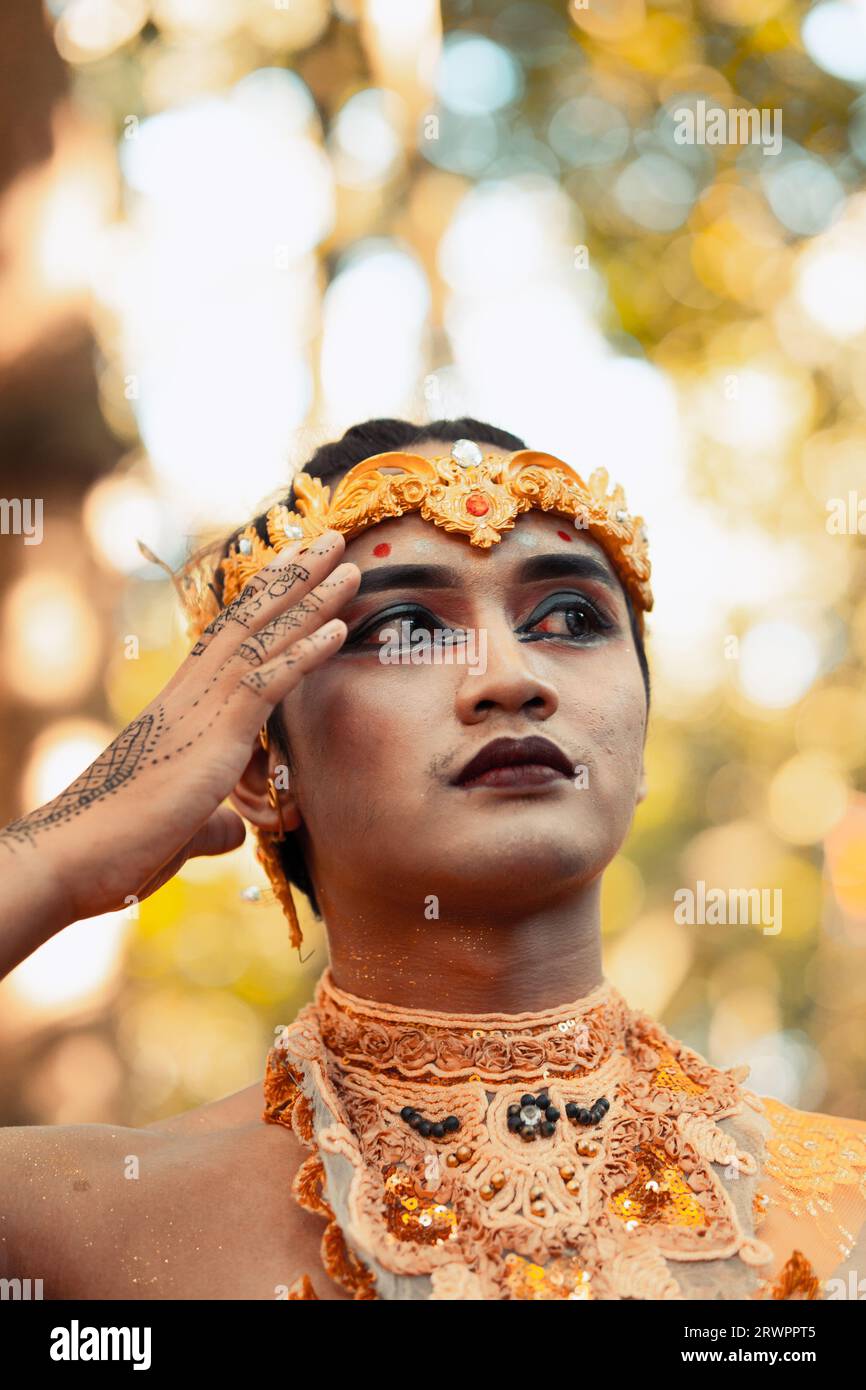 Asian men wearing black eyeshadow and red black lips on her face while ...