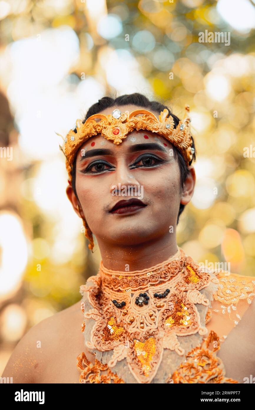 Asian men wearing black eyeshadow and red black lips on her face while ...