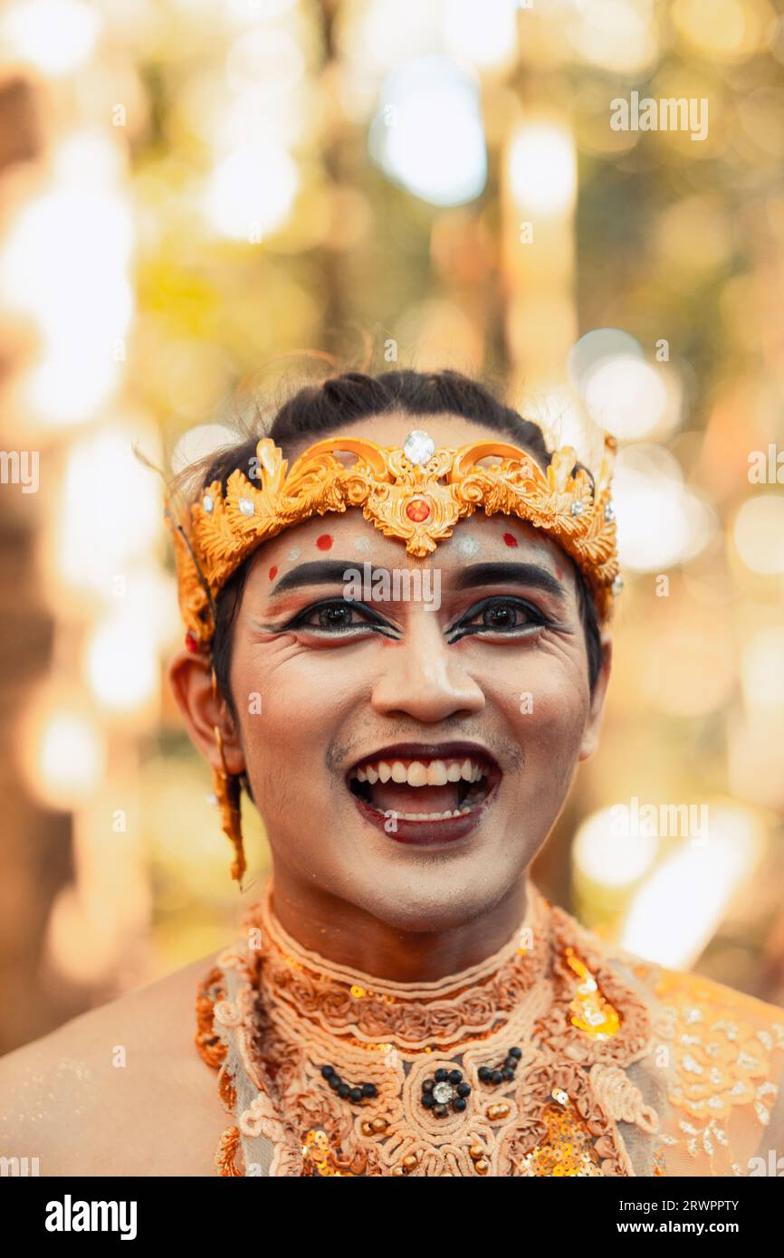 Asian men wearing black eyeshadow and red black lips on her face while ...