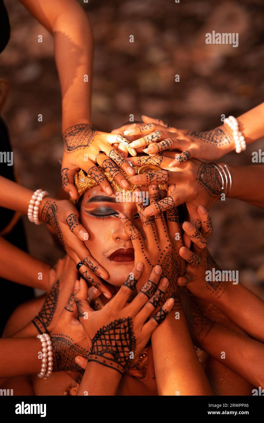 Sad Man Faces covered up by a lot of hands with henna tattoos while ...