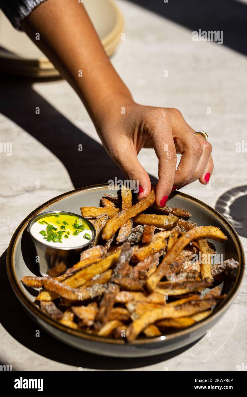 Hand reaching for a fry Stock Photo - Alamy