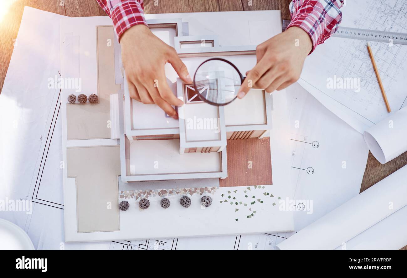 Male architect holding and working on model of architectural house top ...