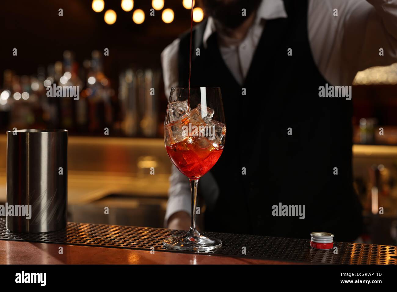 Bartender making fresh alcoholic cocktail at bar counter, closeup Stock ...