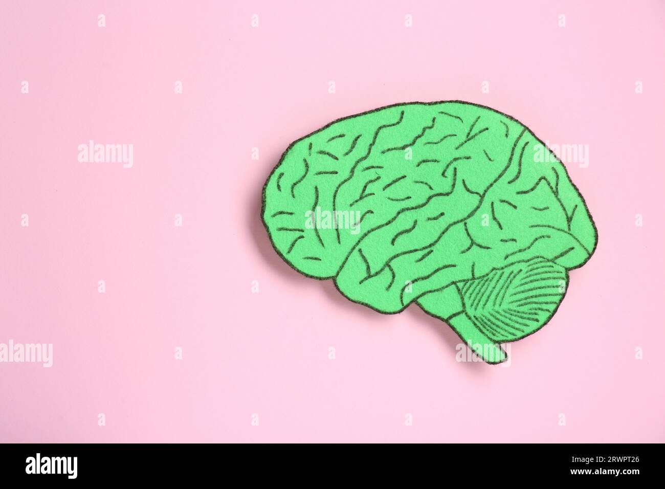 Paper cutout of human brain on pink background, top view. Space for ...