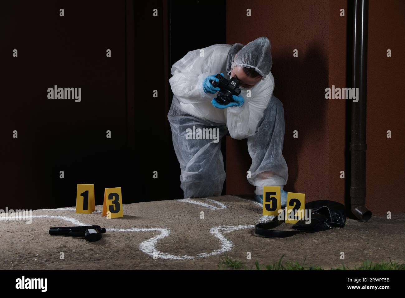 Criminologist in protective suit working at crime scene outdoors. Space for text Stock Photo - Alamy