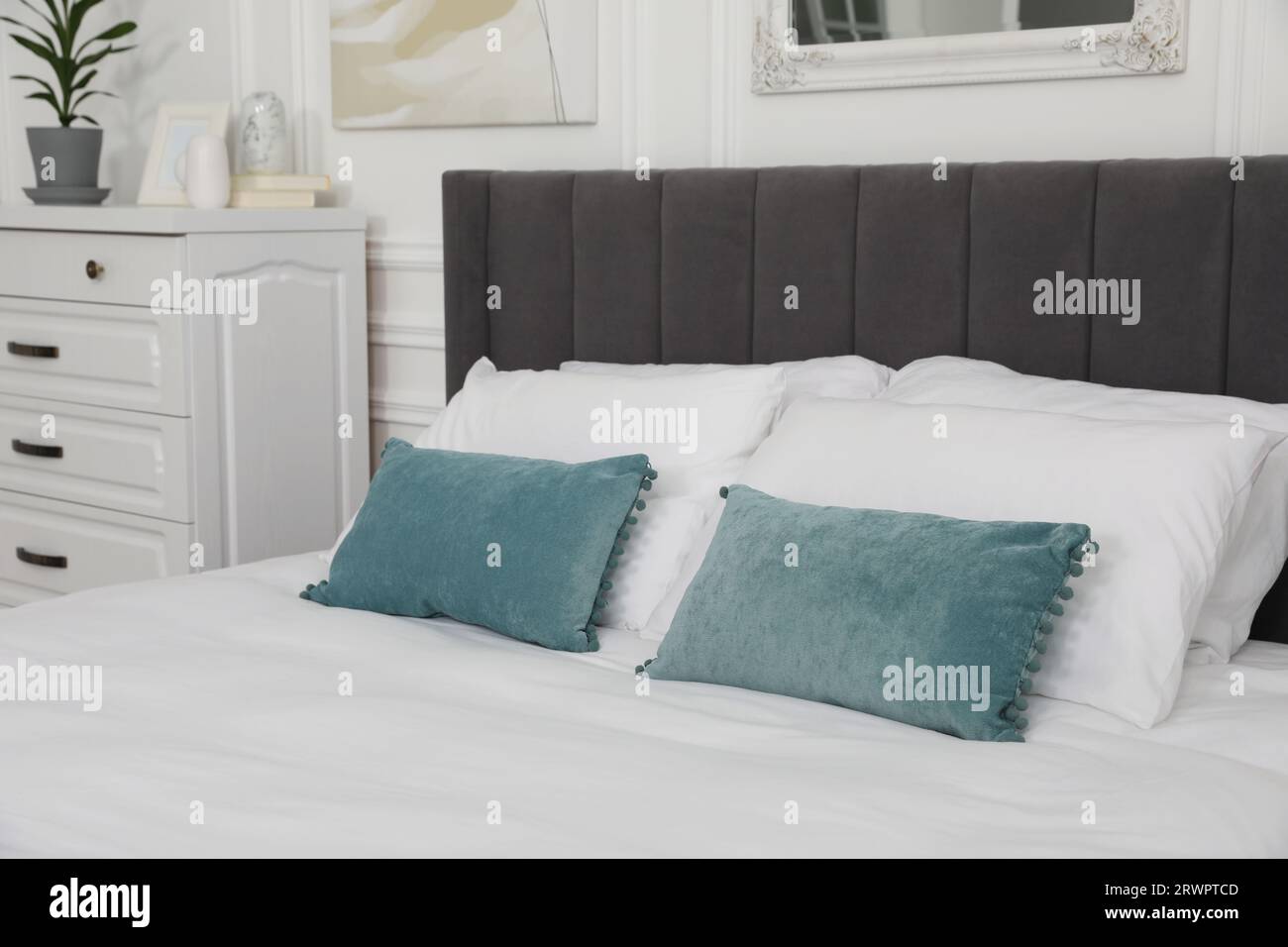 Large comfortable bed with cushions in bedroom. Interior design Stock ...
