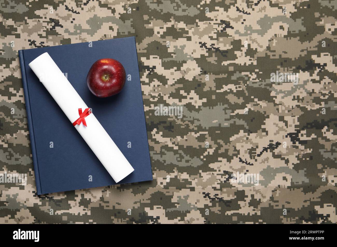 Notebook, apple and diploma on camouflage background, top view with ...