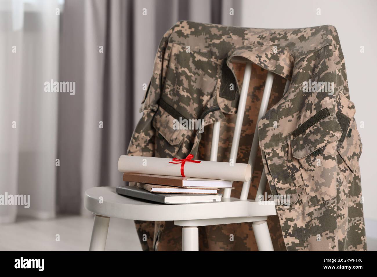Chair with soldier uniform, notebooks and diploma indoors. Military ...