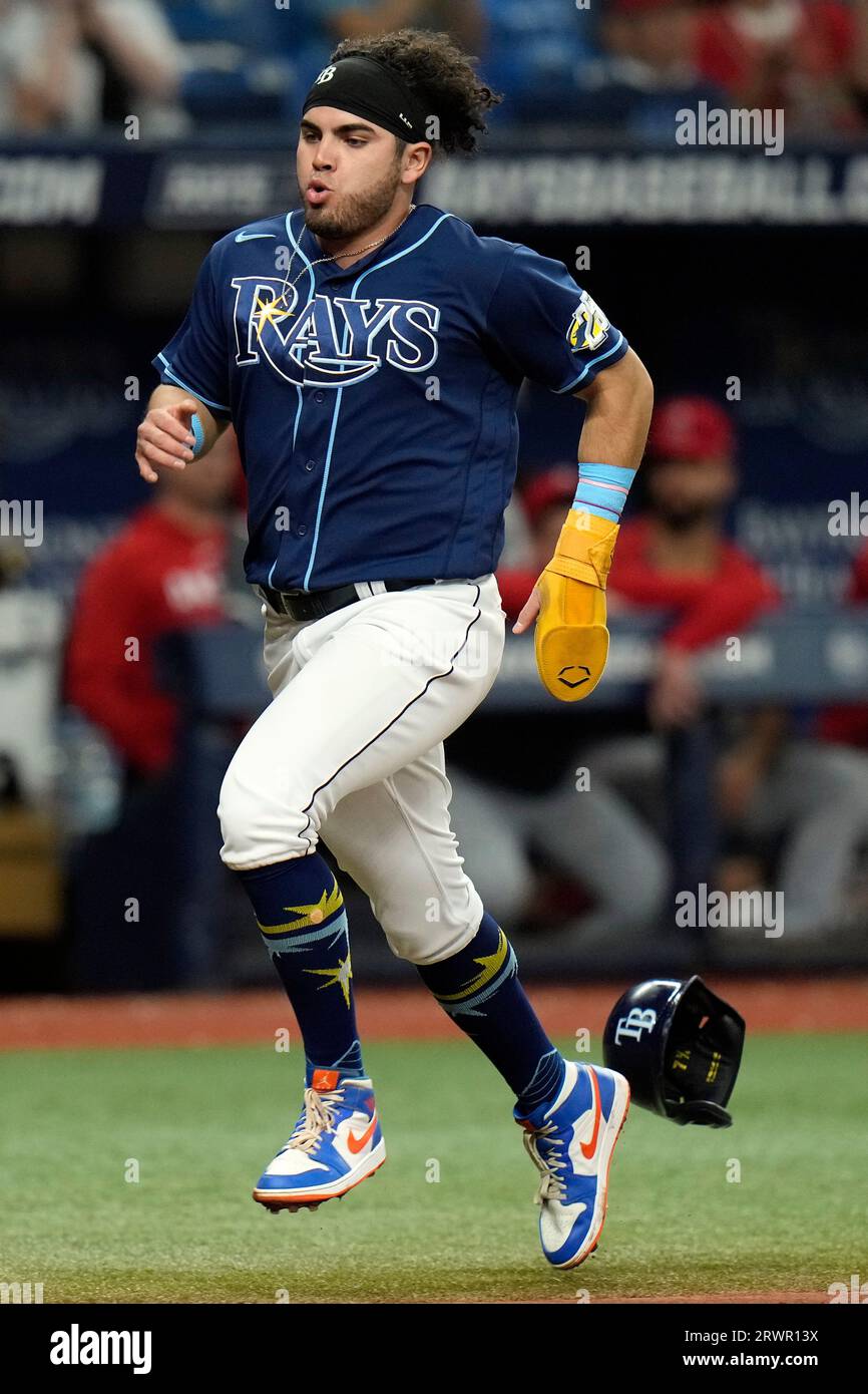 Tampa Bay Rays' Jonathan Aranda loses his helmet as he scores on a two ...
