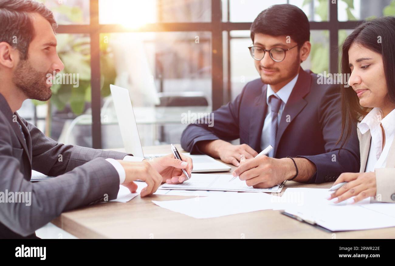 Business people working at desk by windows Stock Photo - Alamy