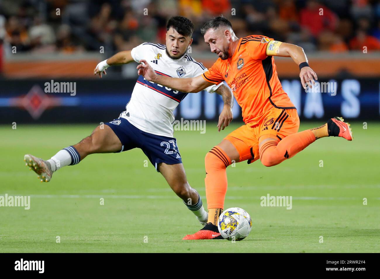 Houston Dynamo midfielder Hector Herrera, right, prepares to kick the ...