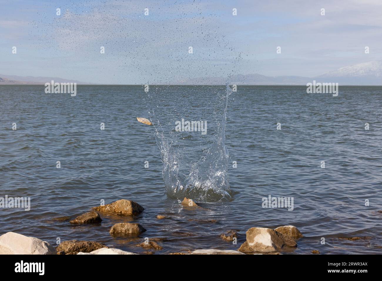 rock splashing into a lake Stock Photo - Alamy