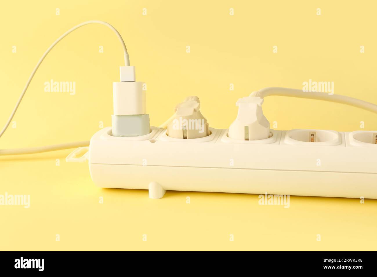 Power socket with plugs on yellow background. Electricity bill concept ...