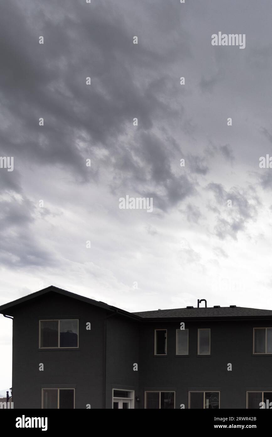 clouds move over a grey house Stock Photo - Alamy