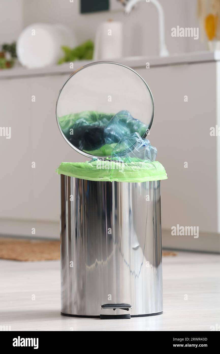 Opened trash bin with garbage in interior of light kitchen Stock Photo ...