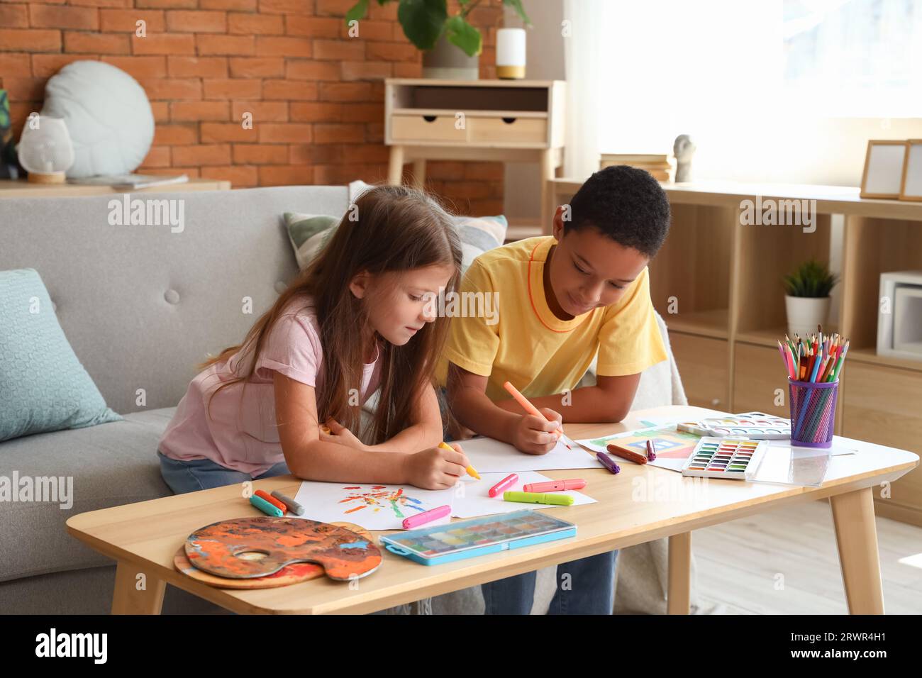 Cute little children drawing at home Stock Photo - Alamy