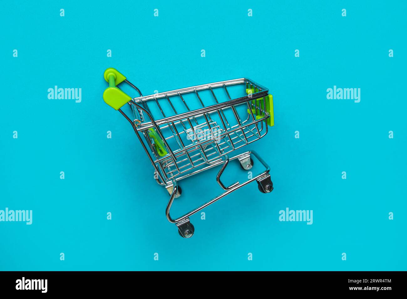 Shopping cart on blue background Stock Photo - Alamy