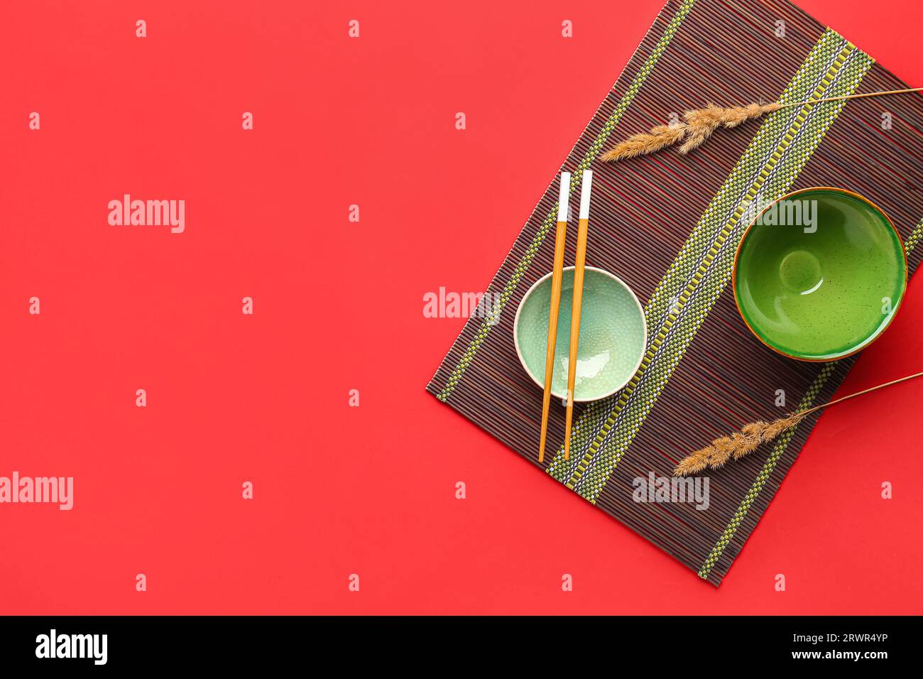 Chinese table setting on red background Stock Photo - Alamy